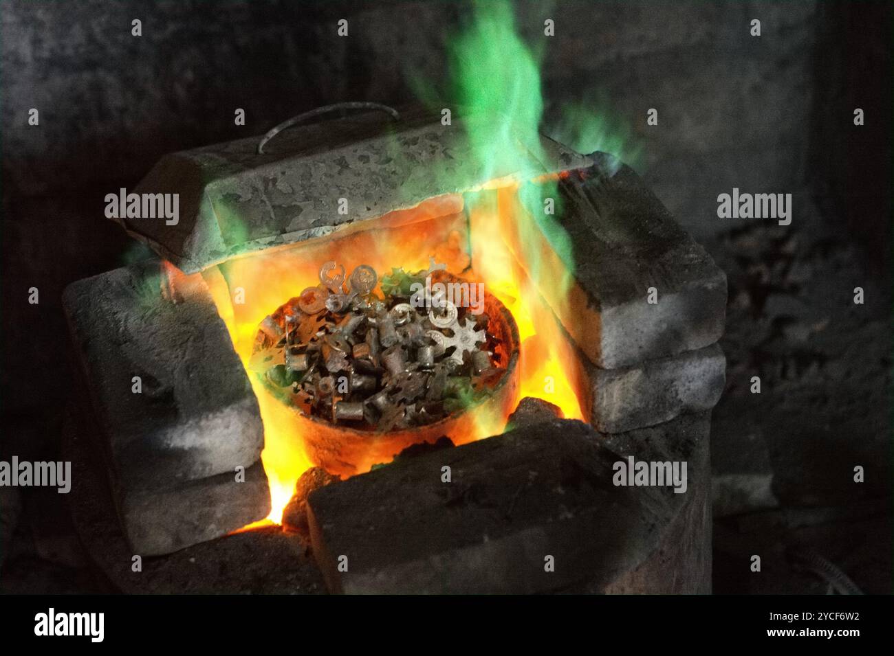 Pieces of metal are melted during the production process of the ...