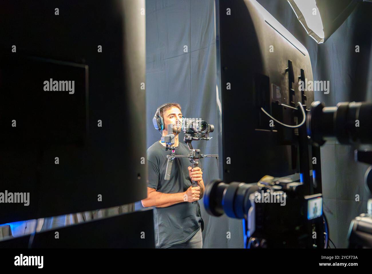 Young Male Camera Operator Using a Gimbal for Filming on a Professional ...