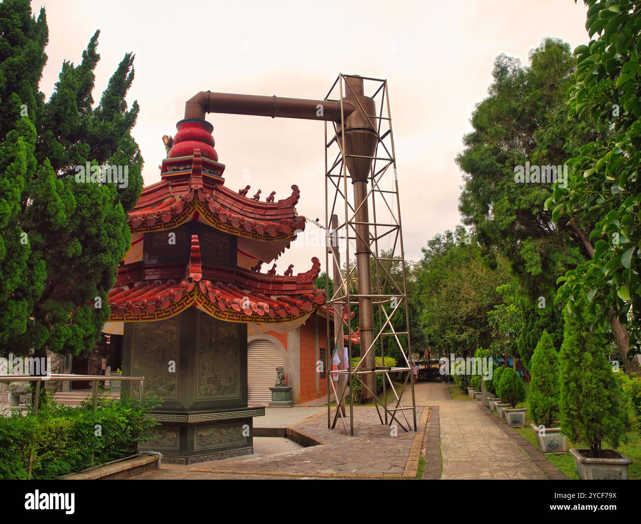 A traditional pagoda roof with intricate red details contrasts with a ...
