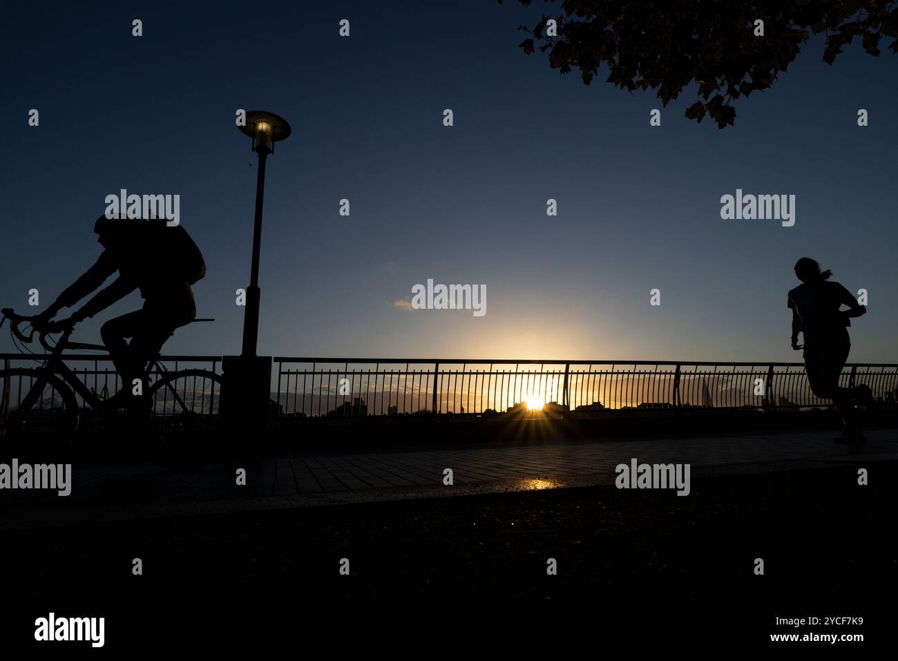 City commuters on their way home during Autumn sunset along the River ...