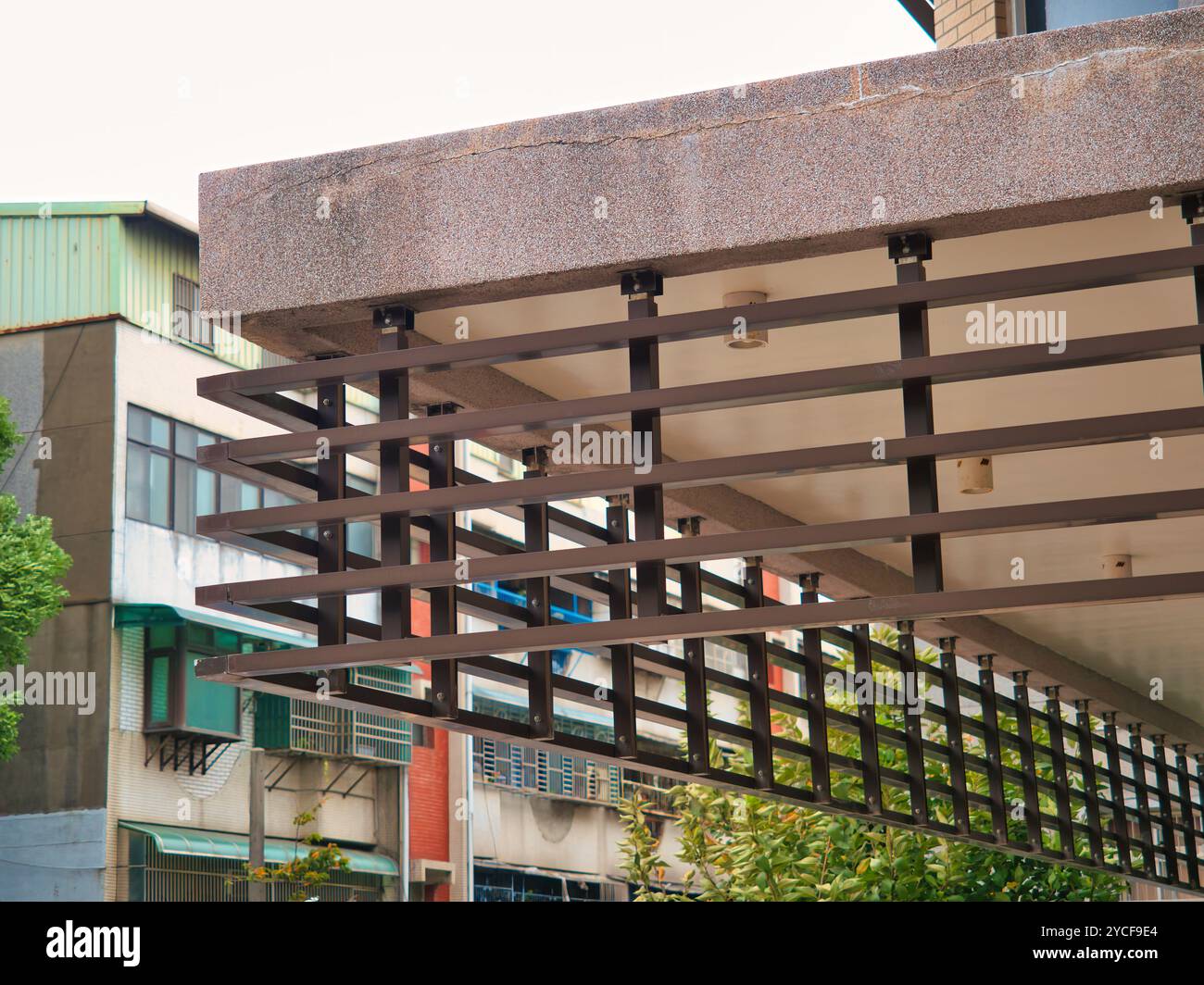 A modern building with brick walls features horizontal metal bars and ...