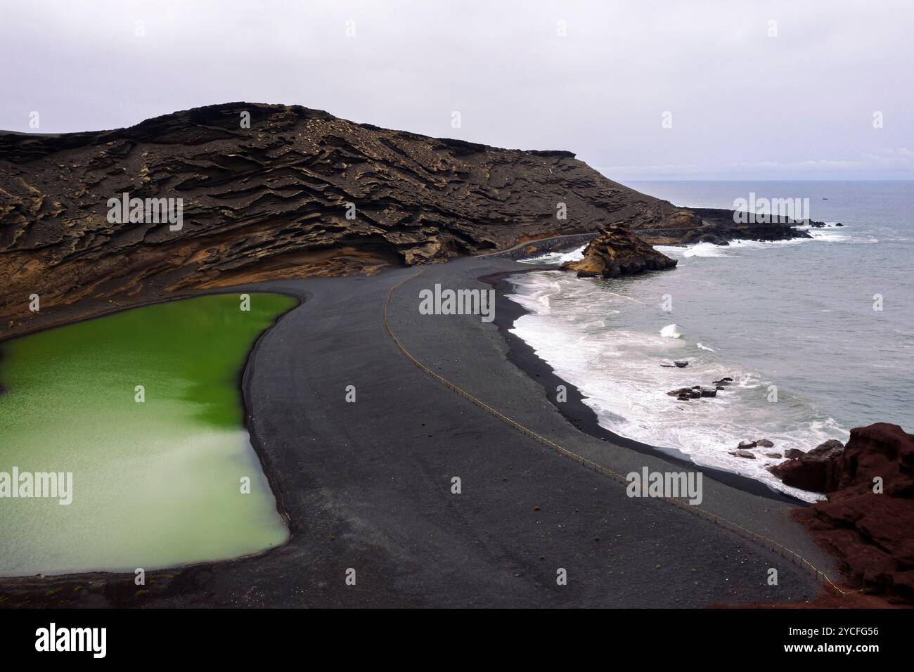 green puddle on a beach of black sand Stock Photo - Alamy