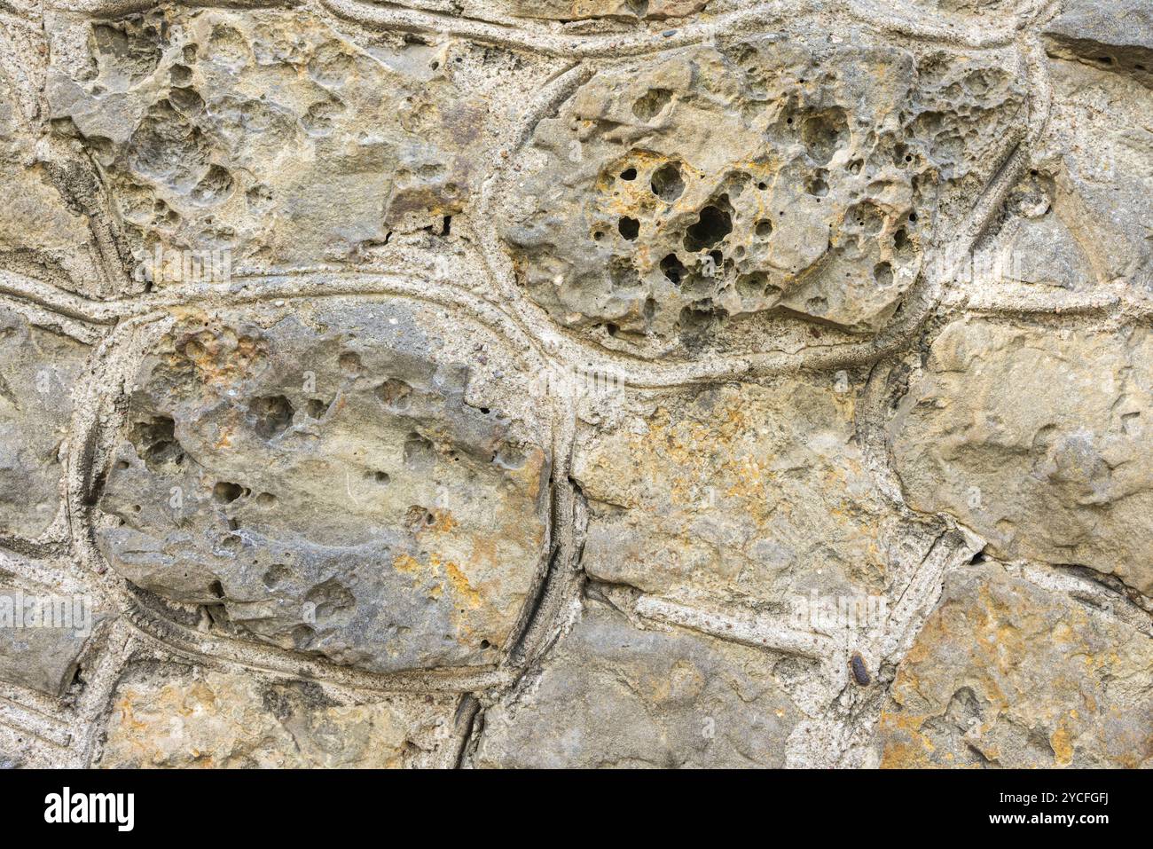 Natural stone wall made of granite stones and white mortar, background ...