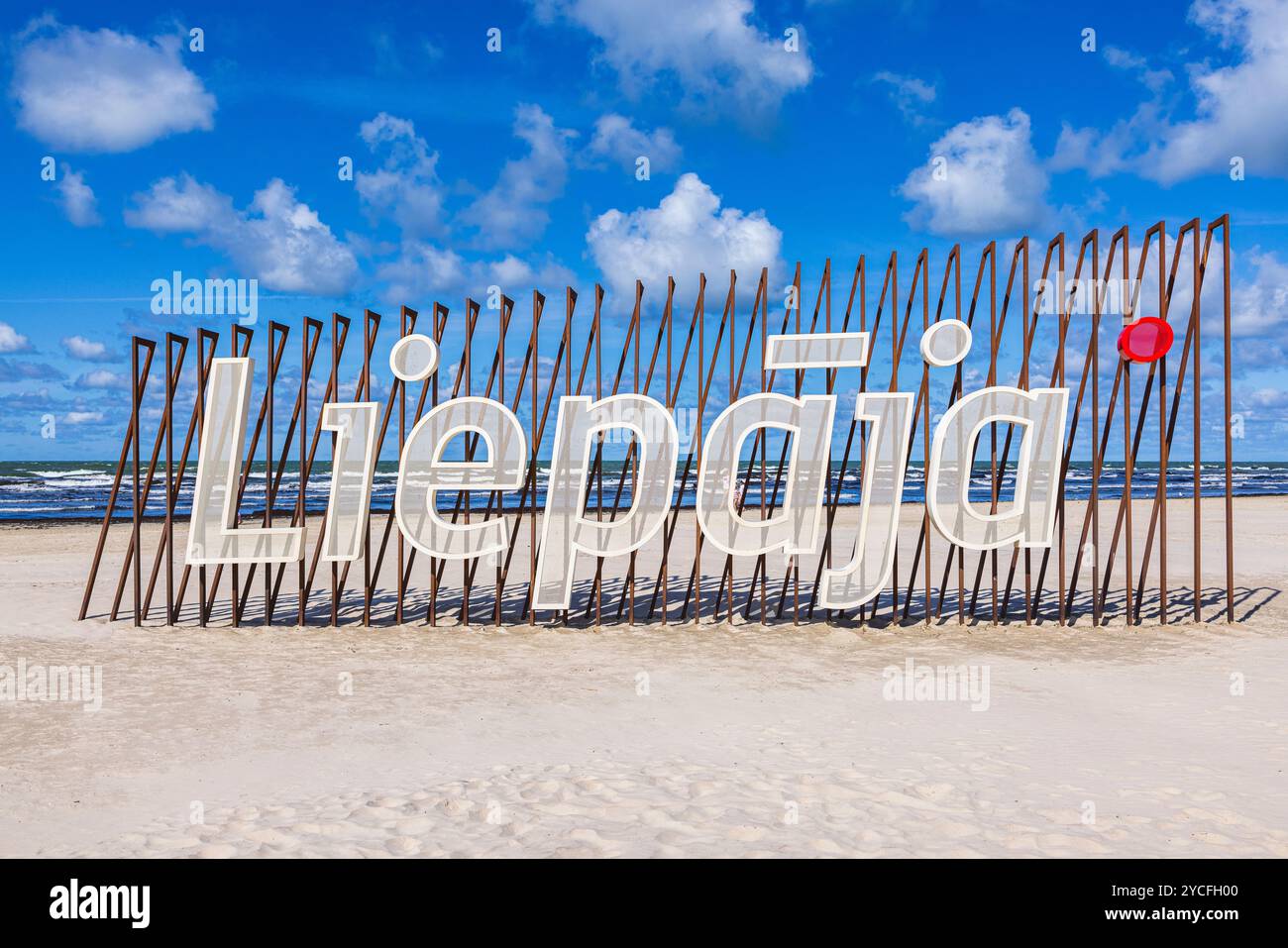 Liepaja sign above a beautiful sky on a white sandy beach, logo of the ...