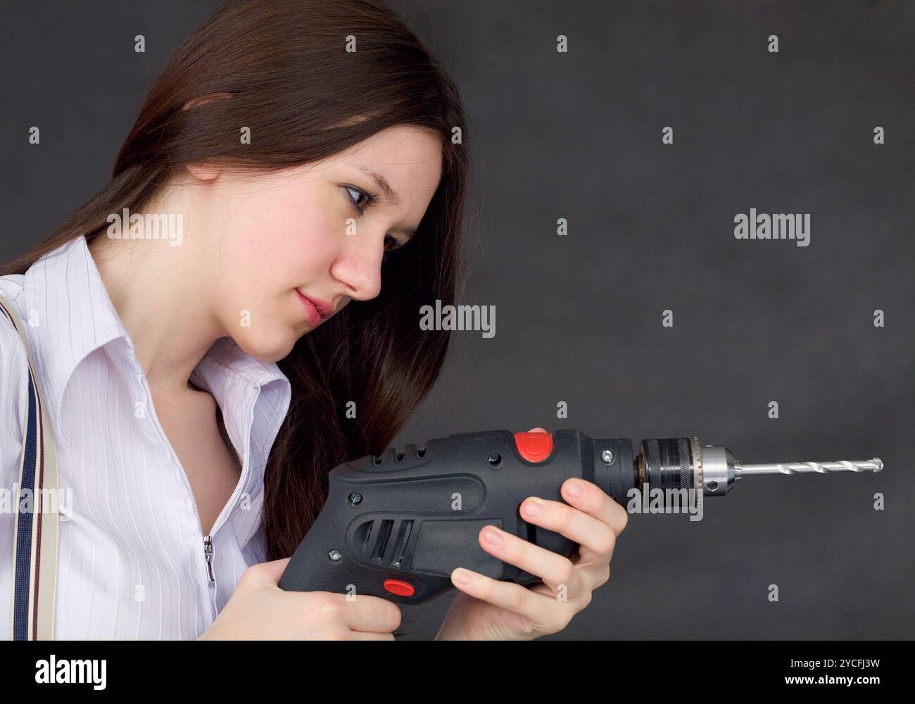 Female student learns to use a drill Stock Photo - Alamy