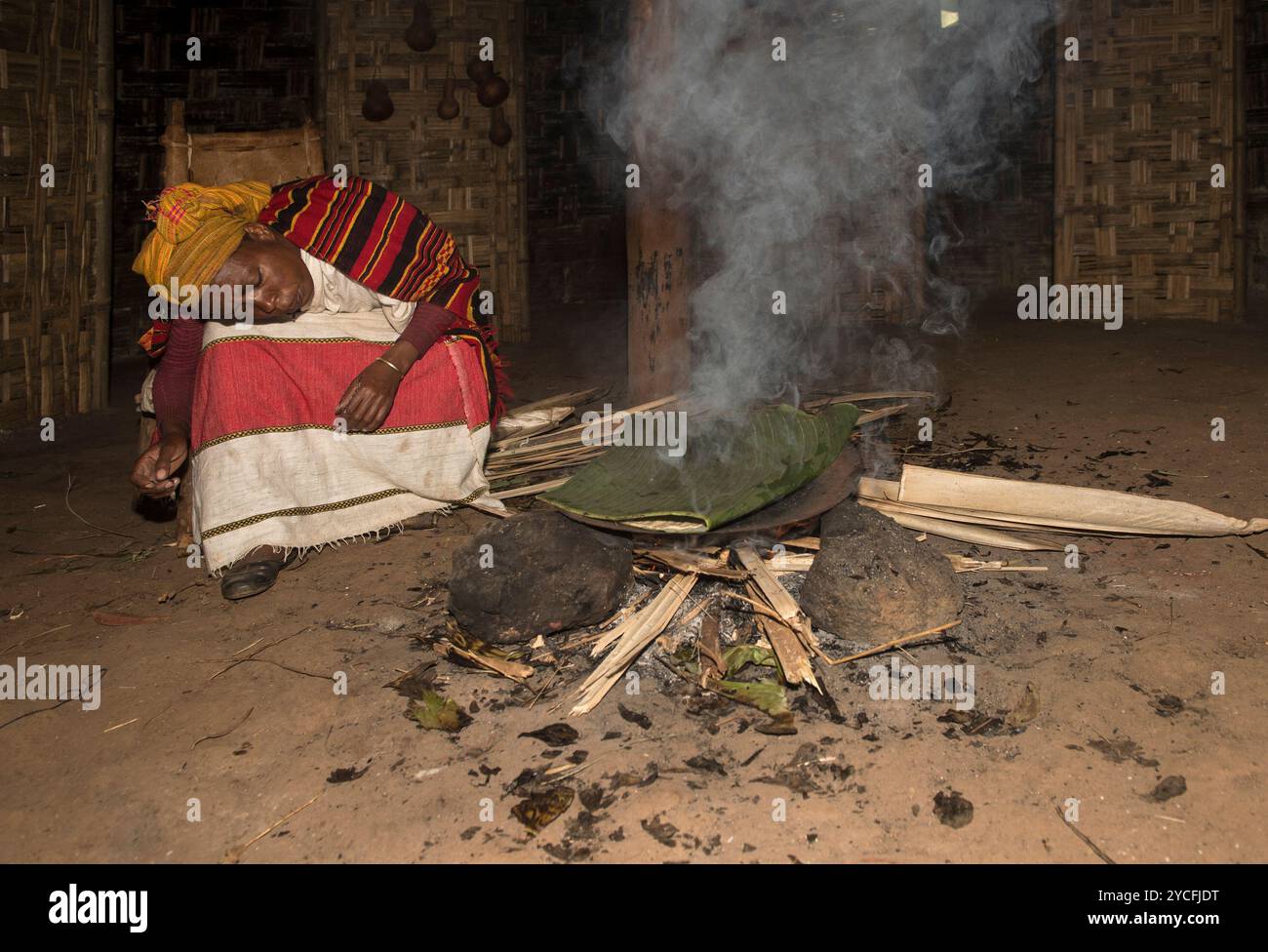Woman from the Dorze ethnic group supervises the open wood fire for ...