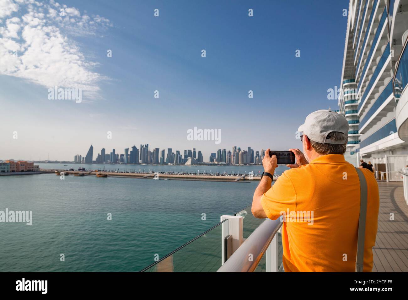 Tourist enjoys the view and films the skyscrapers, skyline, Mwani Qatar ...