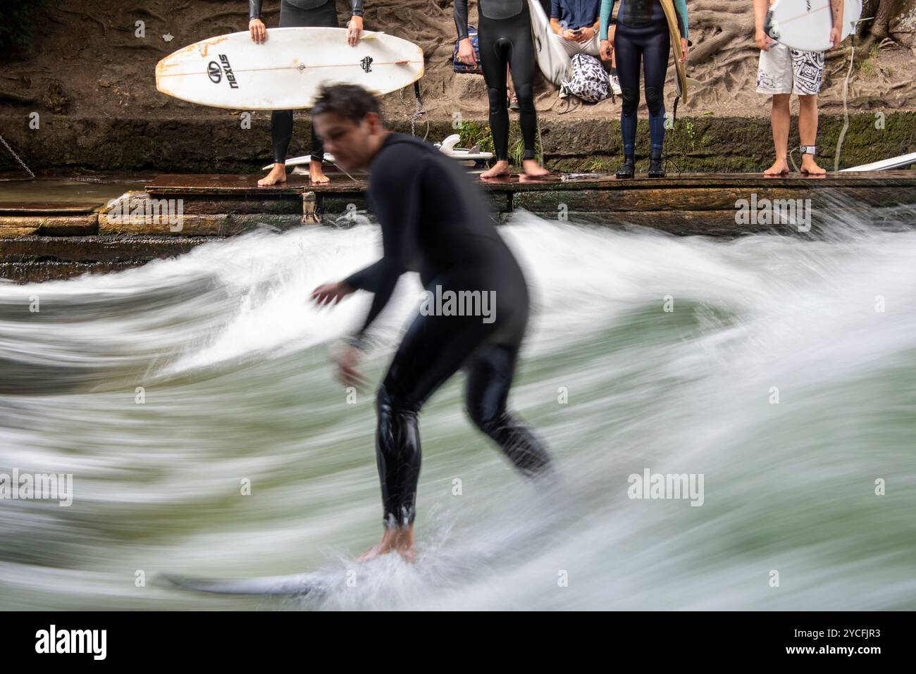 Surfer riding the eisbach wave in the english garden hi-res stock ...