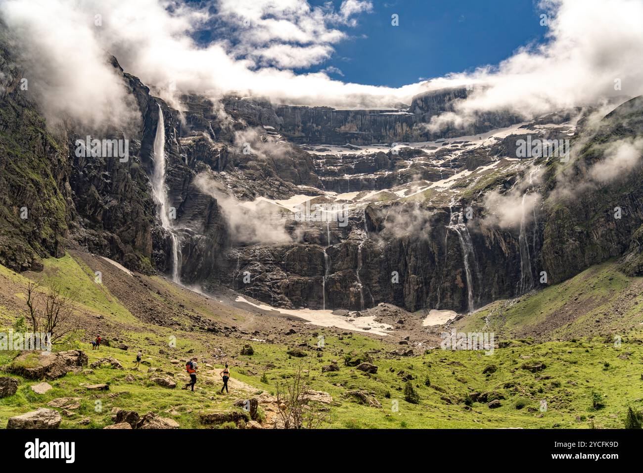 Hikers in the cloudy cirque de gavarnie basin hi-res stock photography ...
