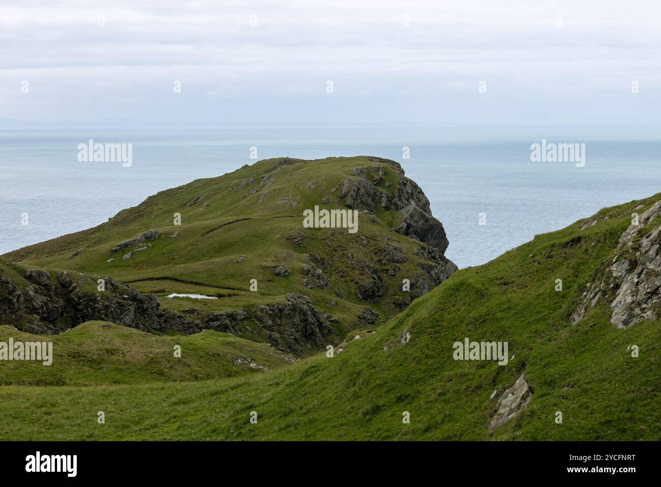 The cliffs curve like a wave against the seamless backdrop of ocean ...