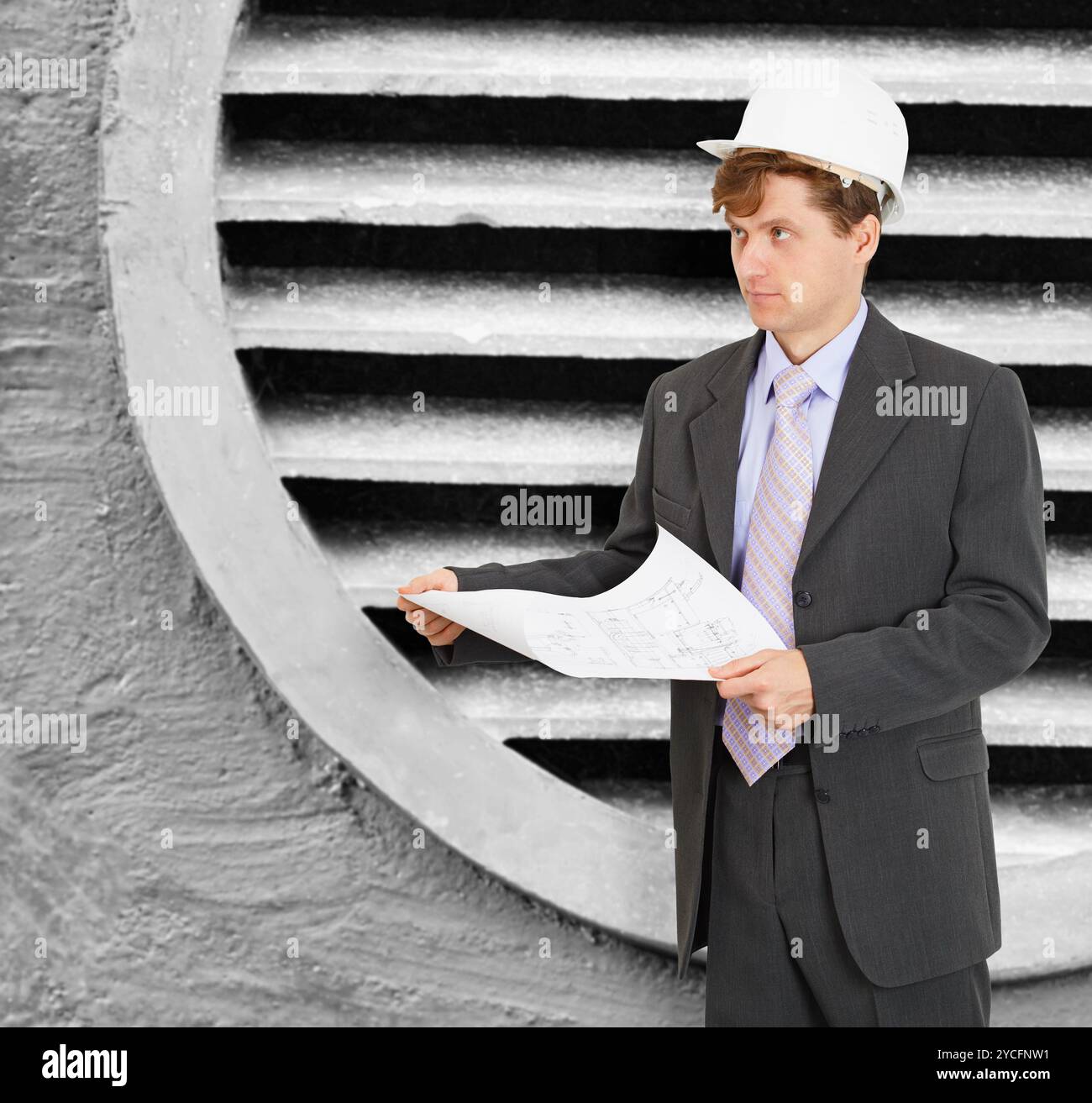 Engineer - designer in helmet with drawings Stock Photo - Alamy
