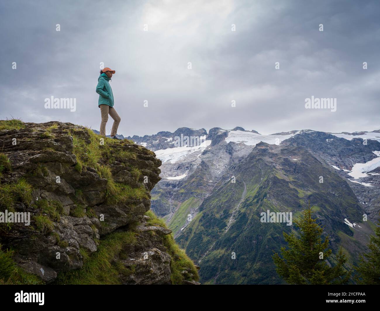 Woman standing on the rocks hi-res stock photography and images - Alamy