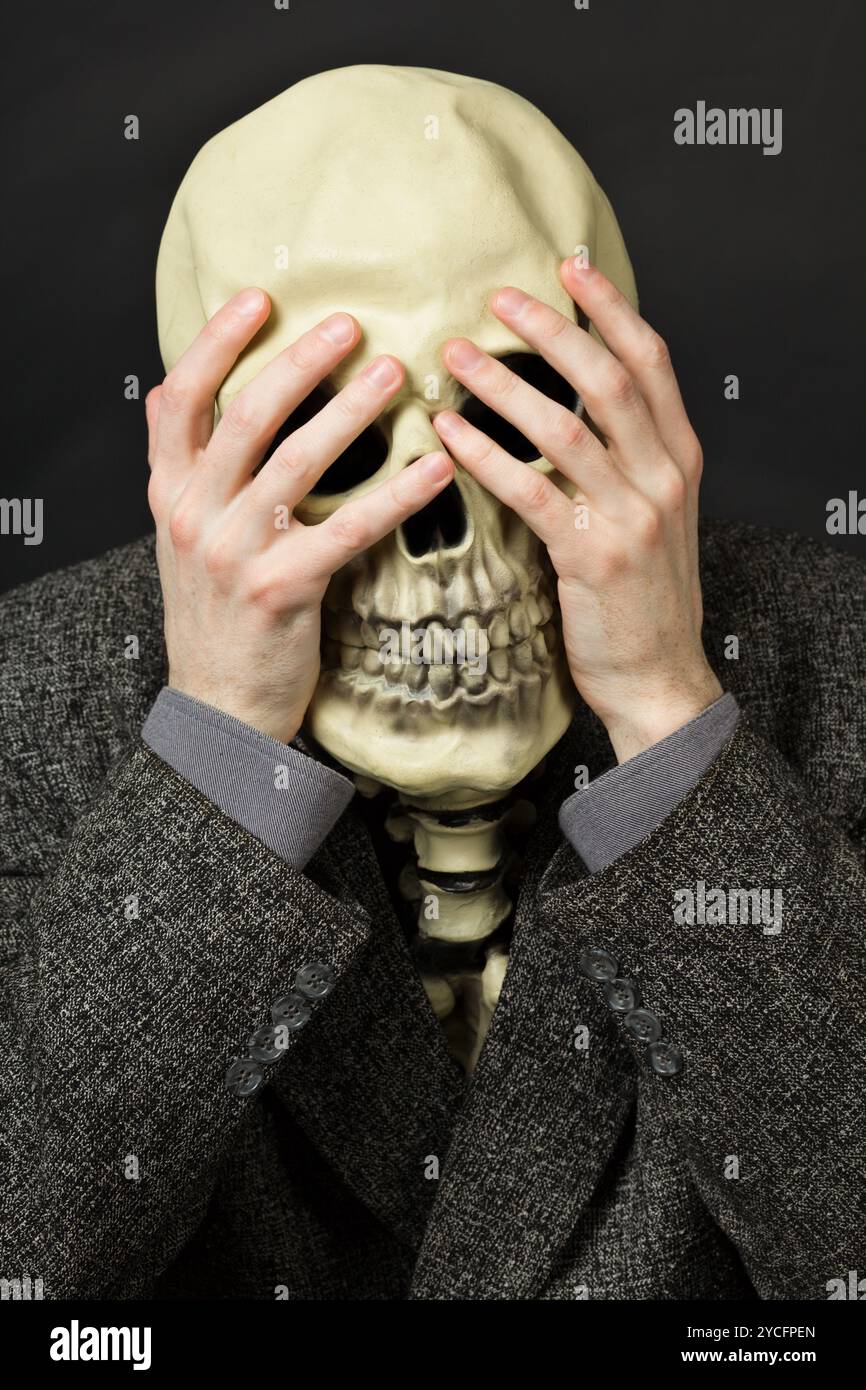 Skeleton covering his eyes Stock Photo - Alamy