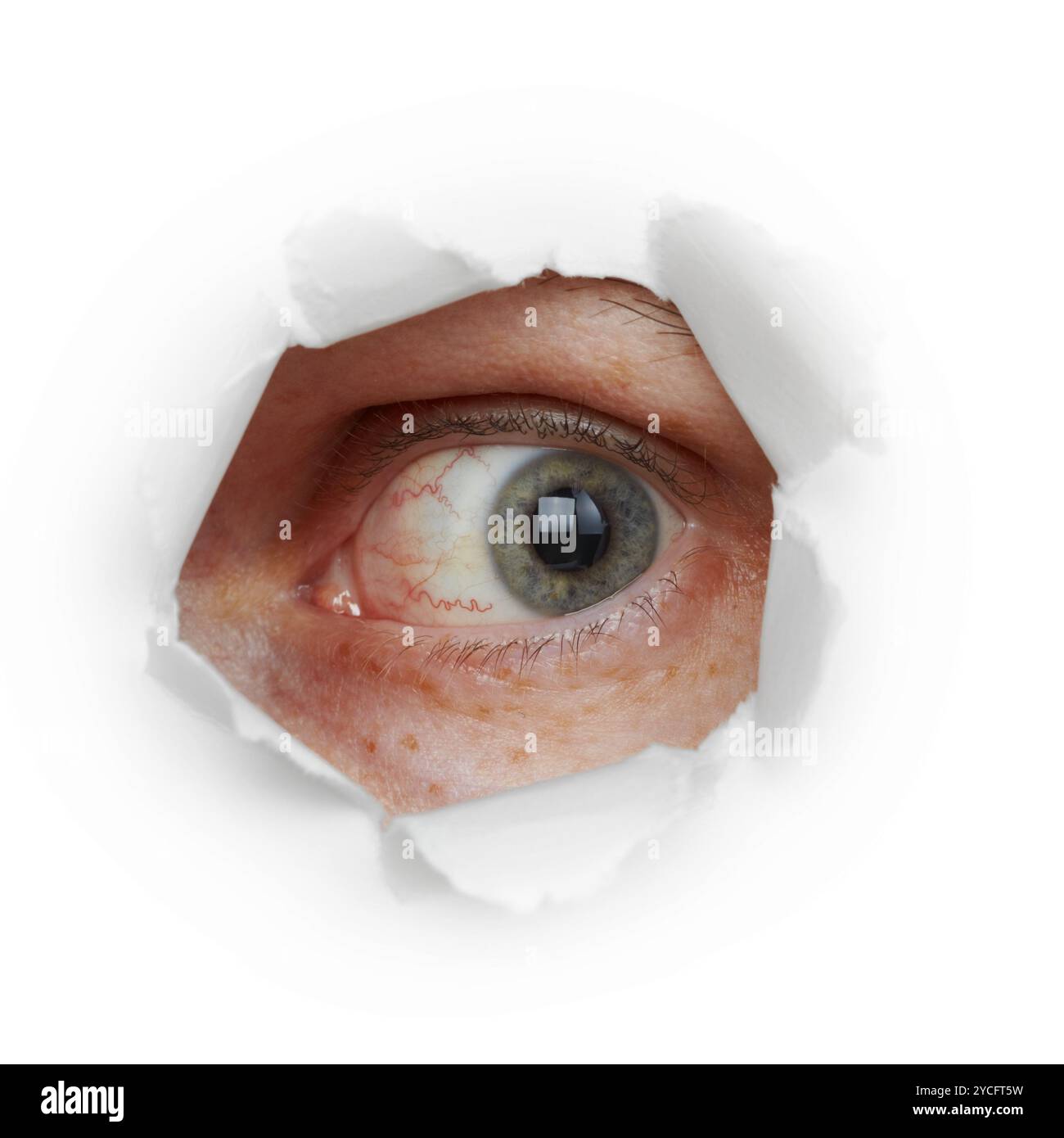 Human eye looks through hole Stock Photo - Alamy
