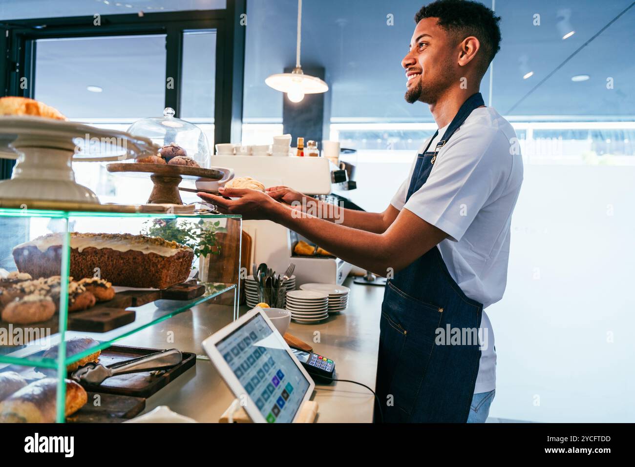 Bakery, happy portrait of hispanic black man in cafe ready for serving ...