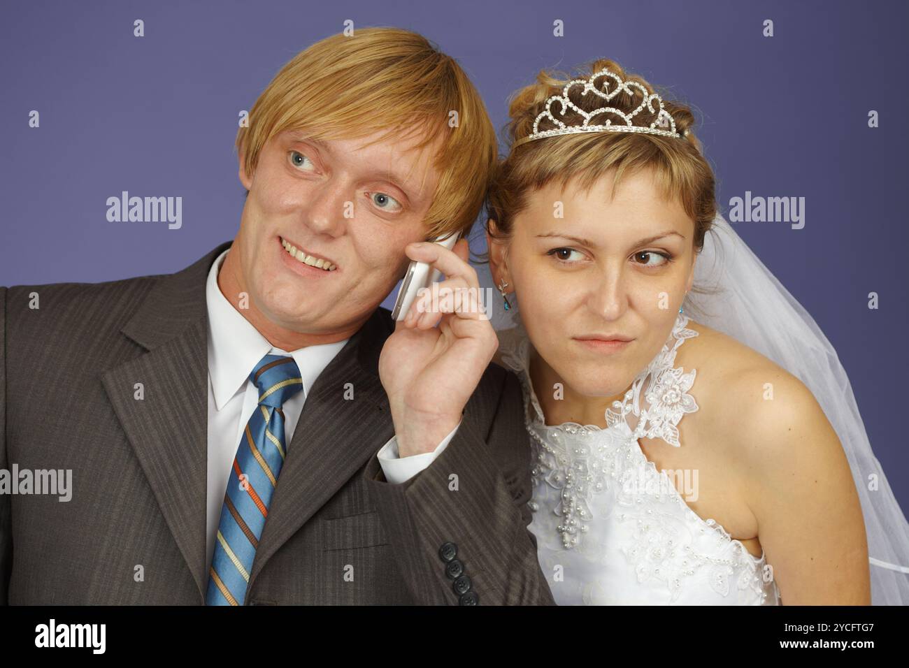 Bride and groom get phone call Stock Photo - Alamy