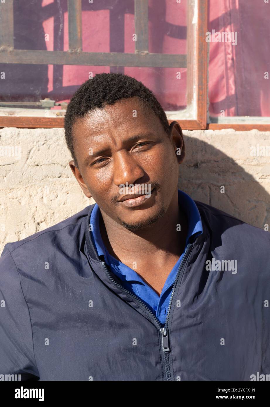 portrait of village single african young man in front of his house ...