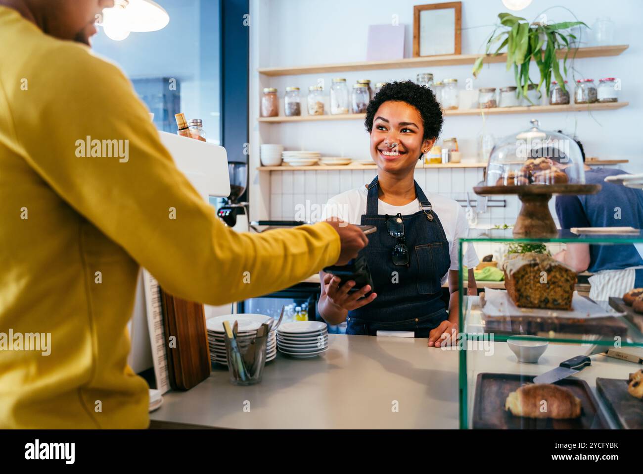 Bakery, happy portrait of black woman in cafe ready for serving pastry ...