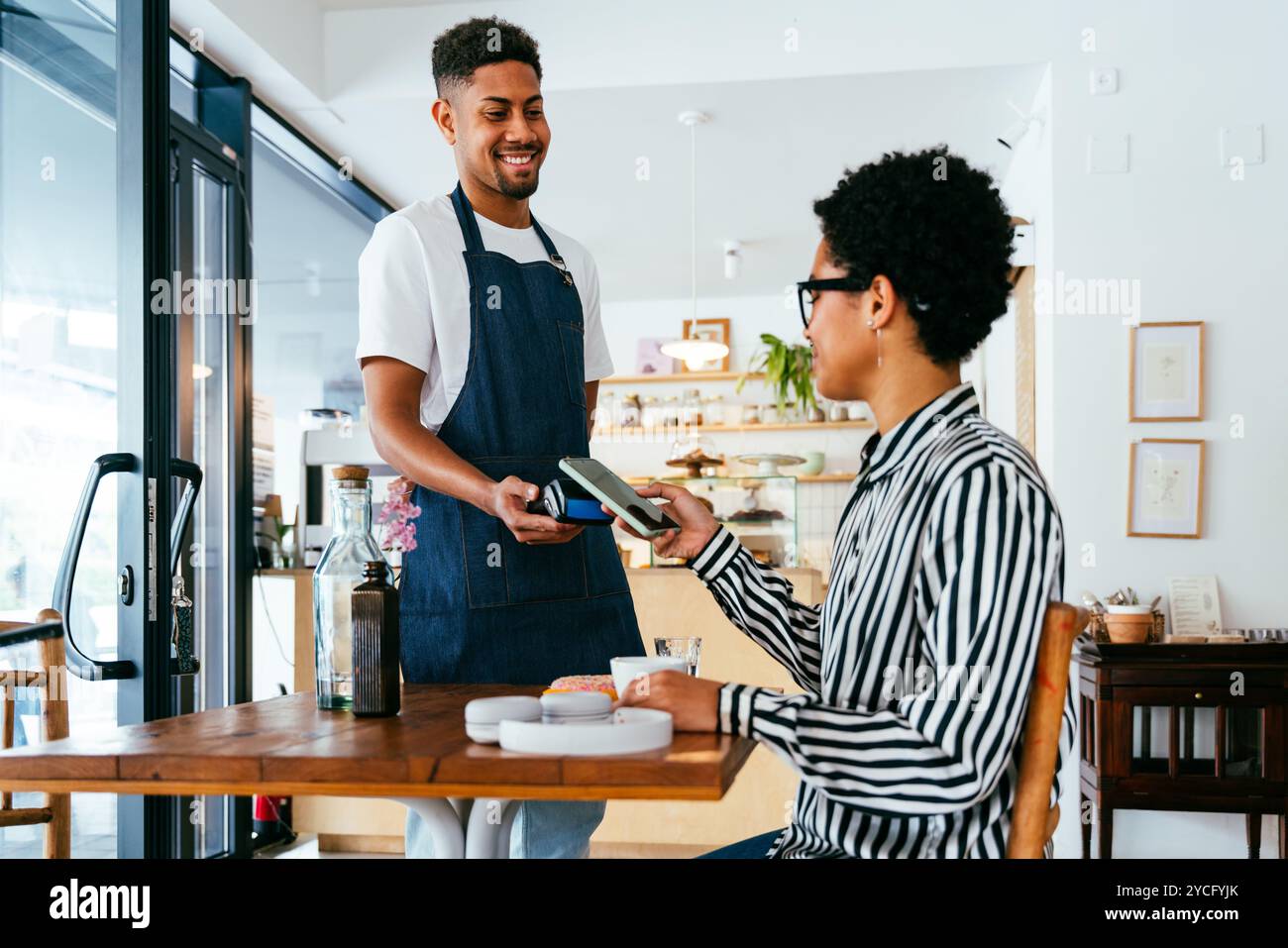 Bakery, happy portrait of hispanic black man in cafe ready for serving ...