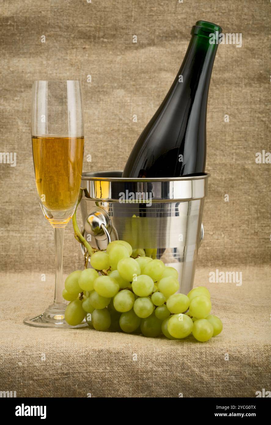Champagne bottle, bucket, goblet and grapes Stock Photo - Alamy