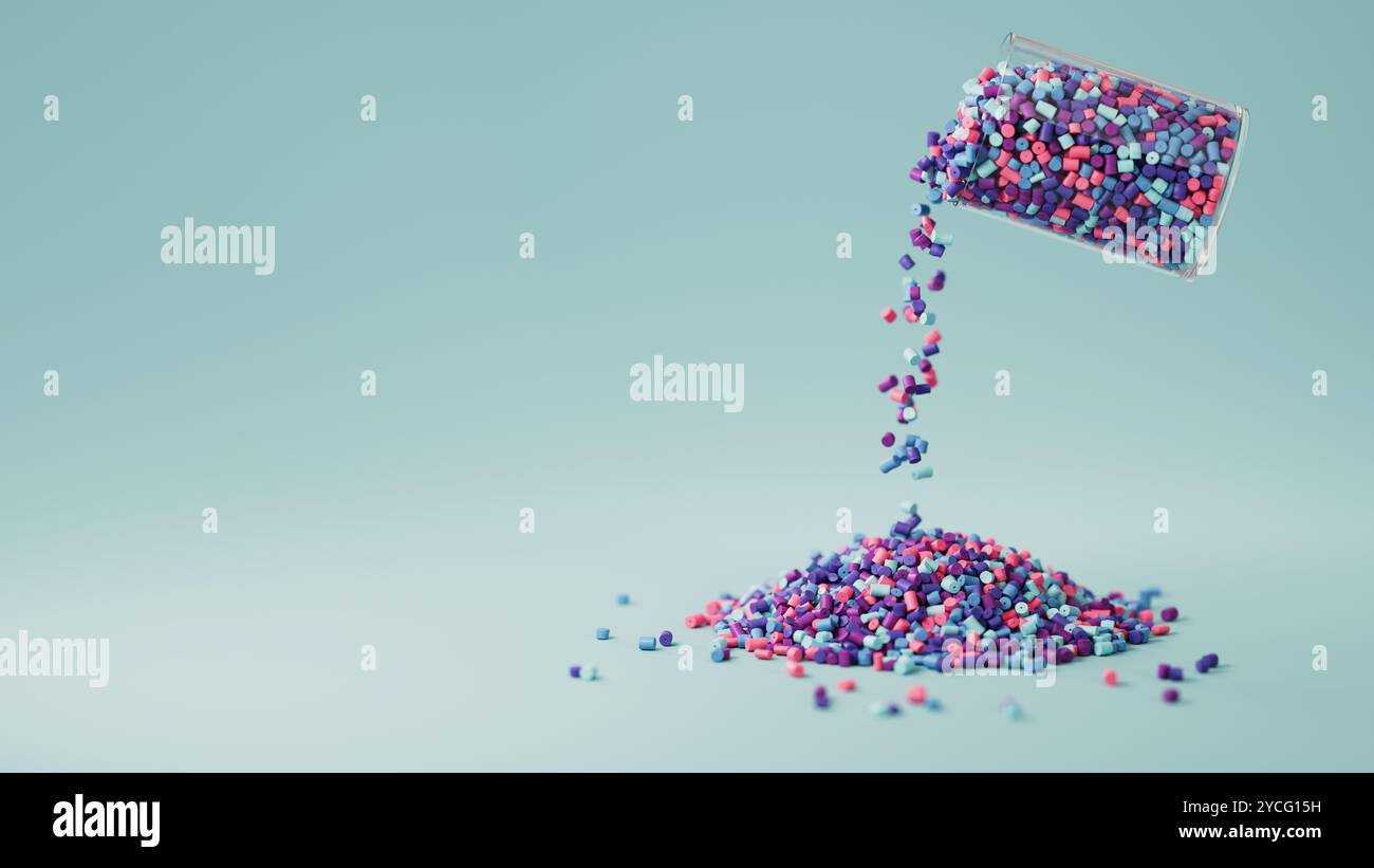 Colorful pastel plastic polypropylene granules pouring from the glass ...