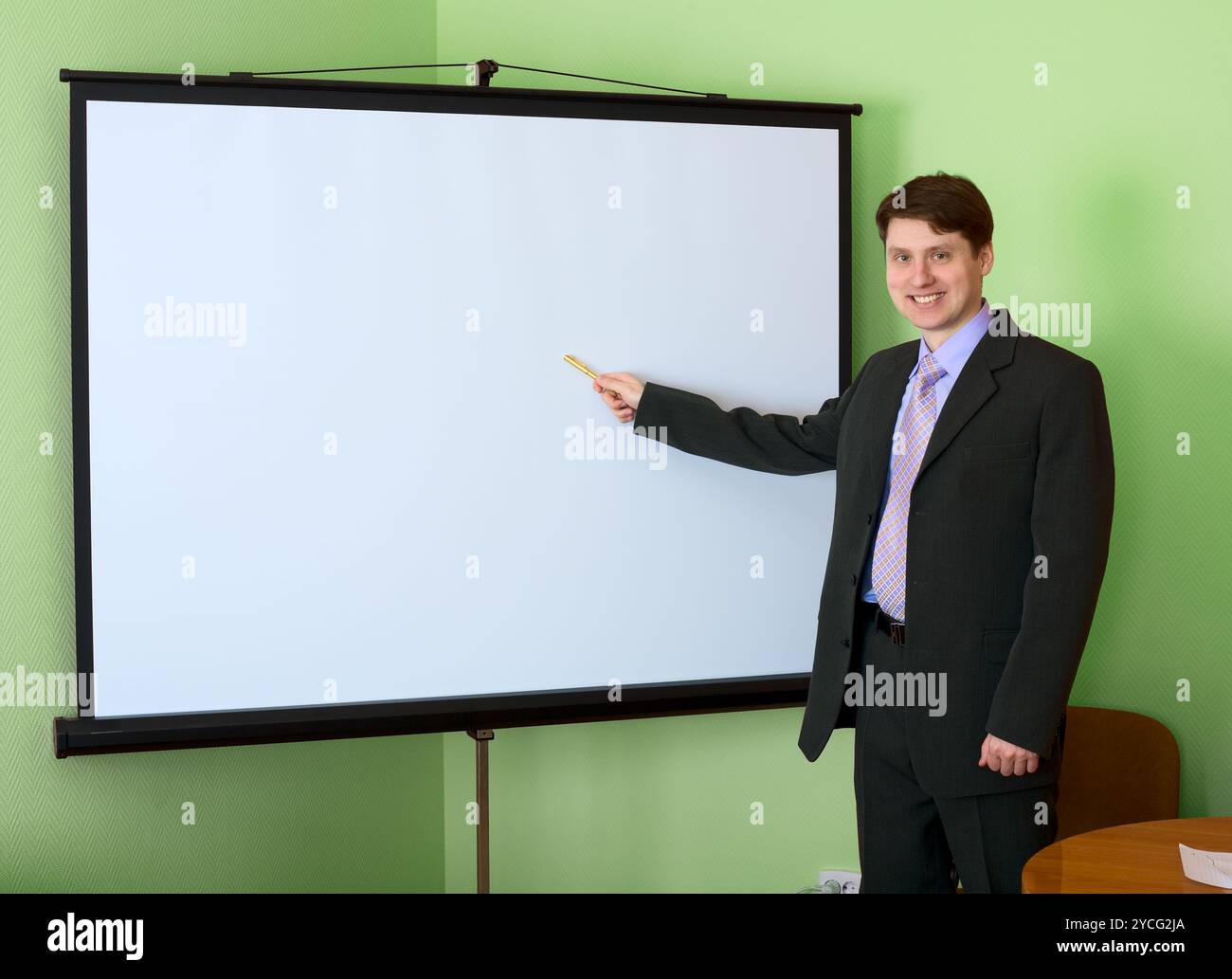 The businessman standing near the white screen Stock Photo - Alamy