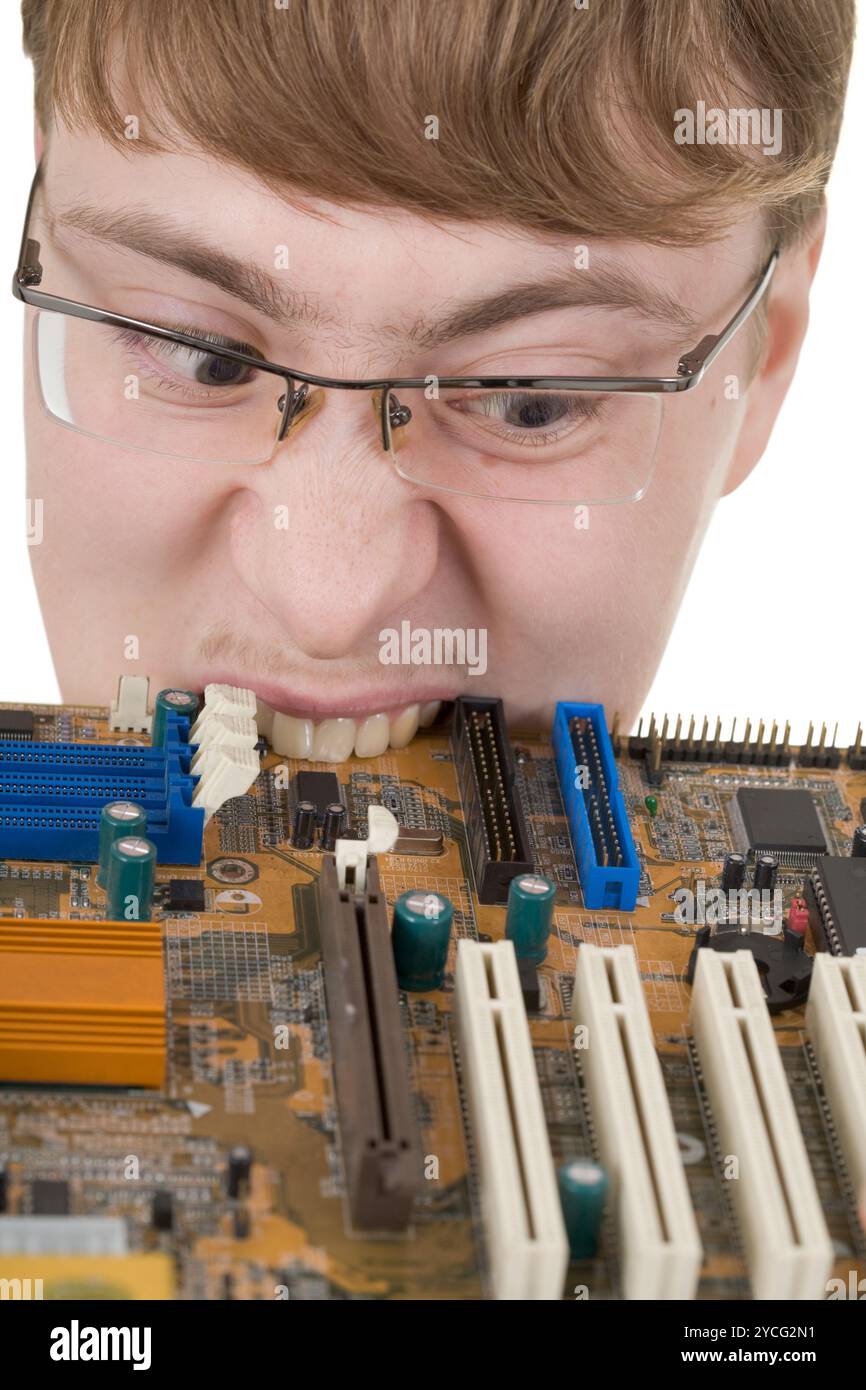 Guy bites an old circuit board Stock Photo - Alamy