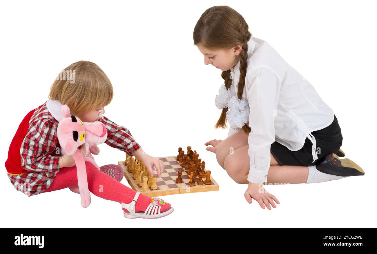 Girl teaching little girl play chess on white Stock Photo - Alamy