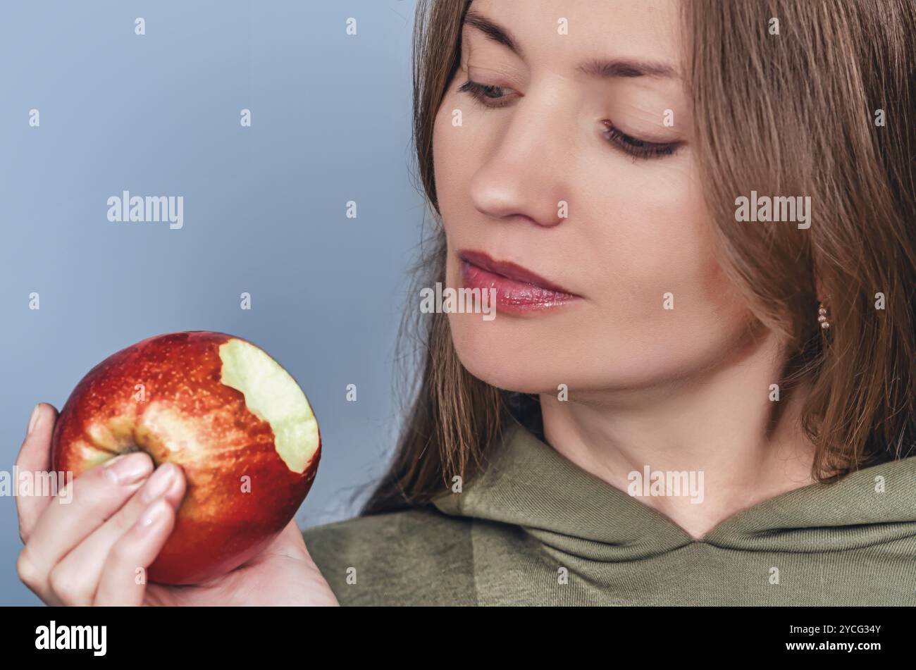 Close-up bitten red apple held by smiling woman. Concept of healthy ...