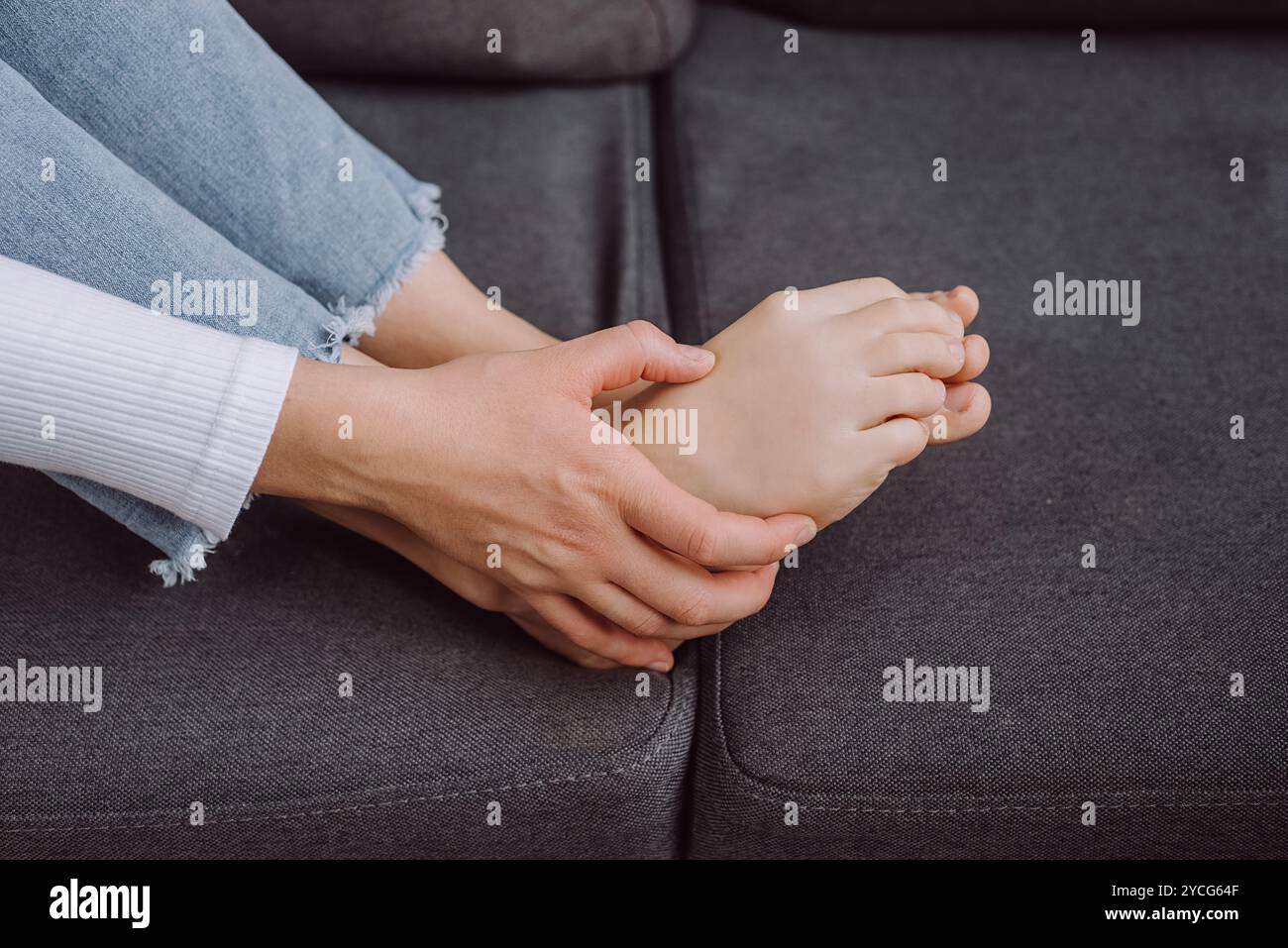 Close up of young woman hands scratch feet, itch foot, problem itchy ...