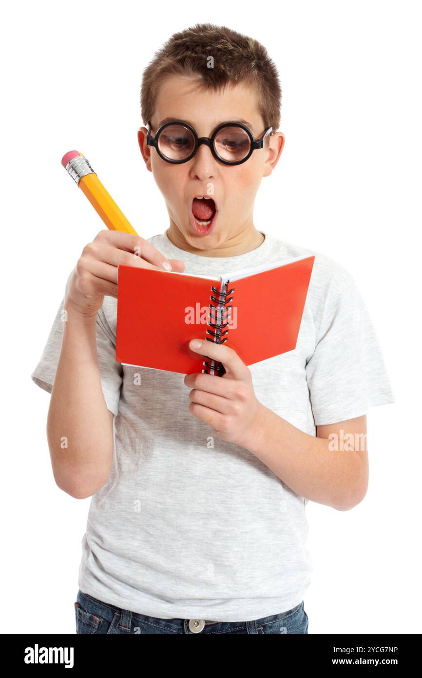 A comical boy student in geeky glasses writing in a book Stock Photo ...