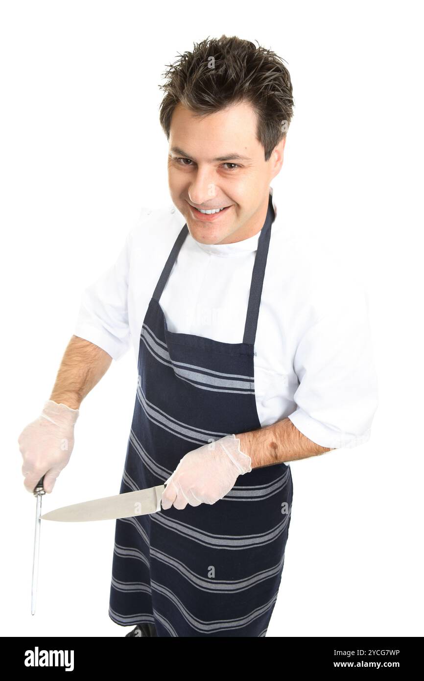Smiling butcher or chef sharpens knife Stock Photo - Alamy