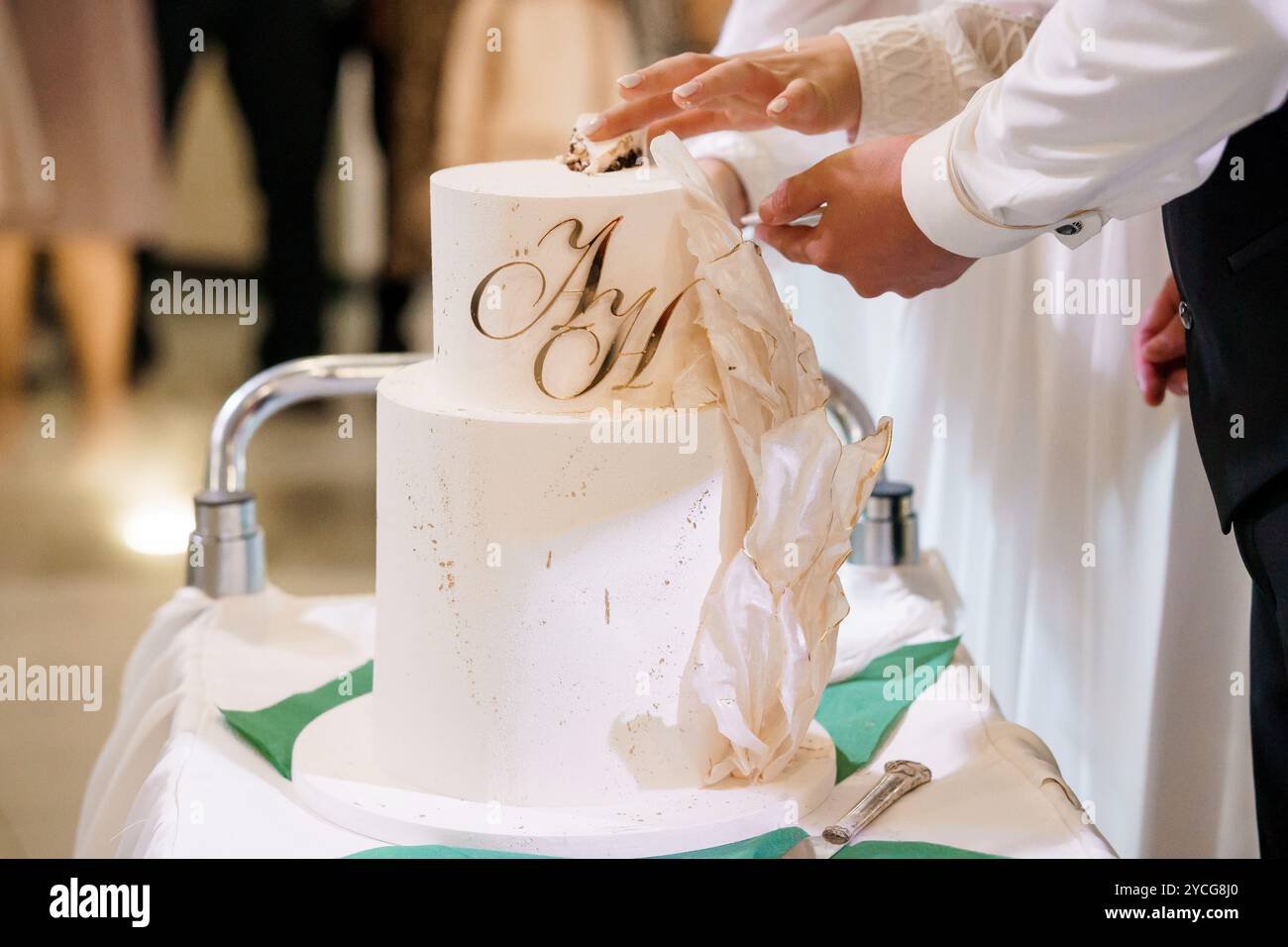 Elegant Wedding Cake Cutting Ceremony with Monogram Detail Stock Photo ...