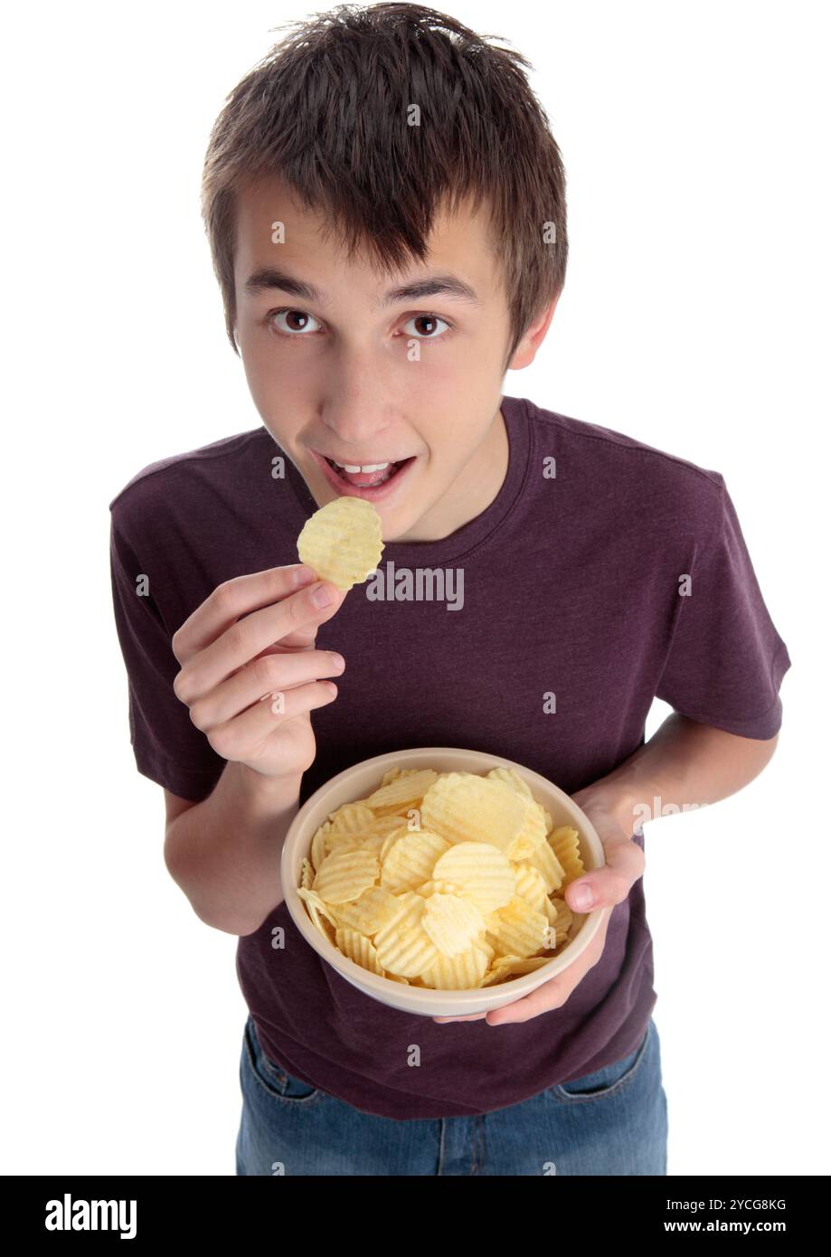 Boy eating chip snack and looking up Stock Photo - Alamy