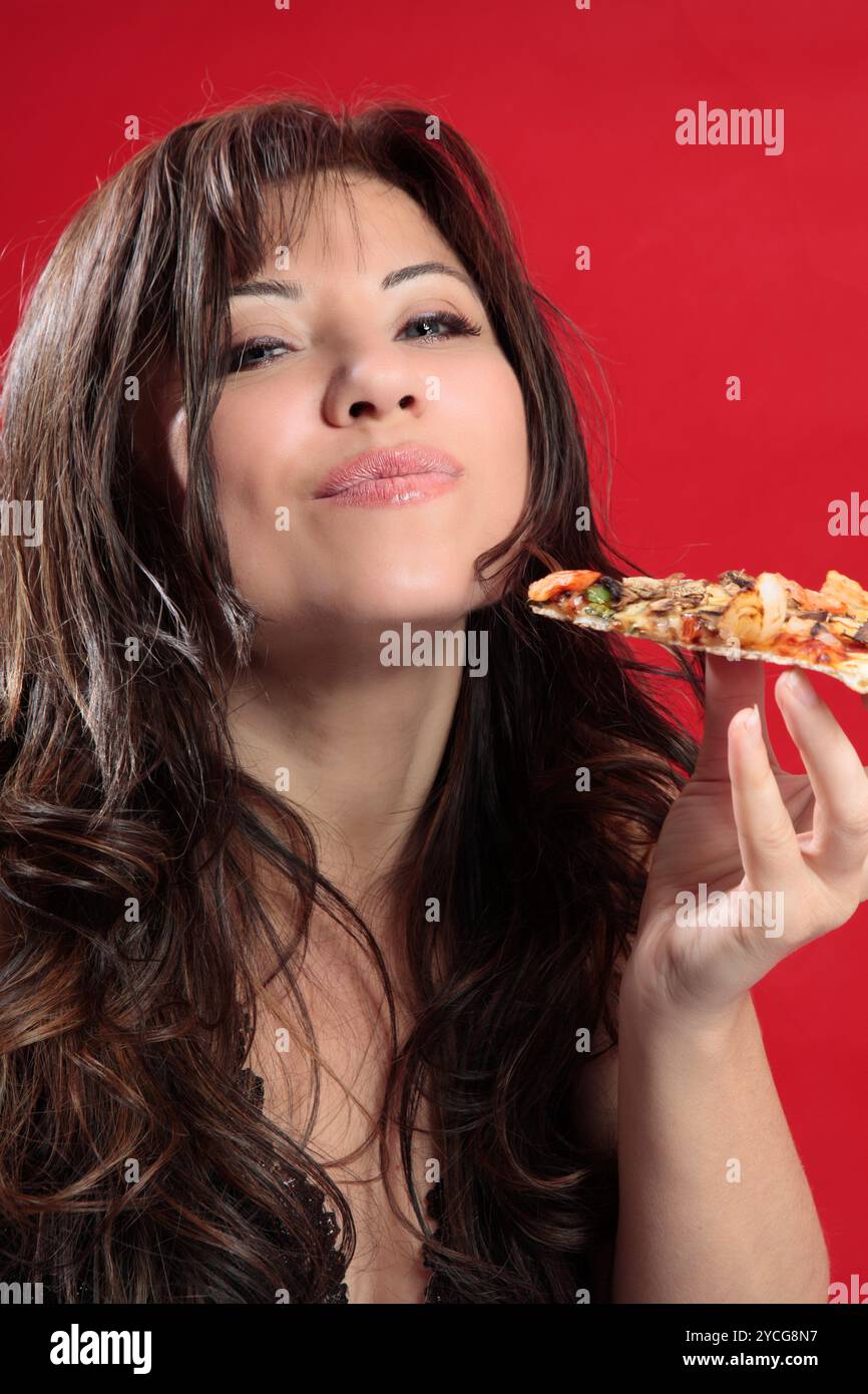 Mmmm woman enjoying pizza Stock Photo - Alamy