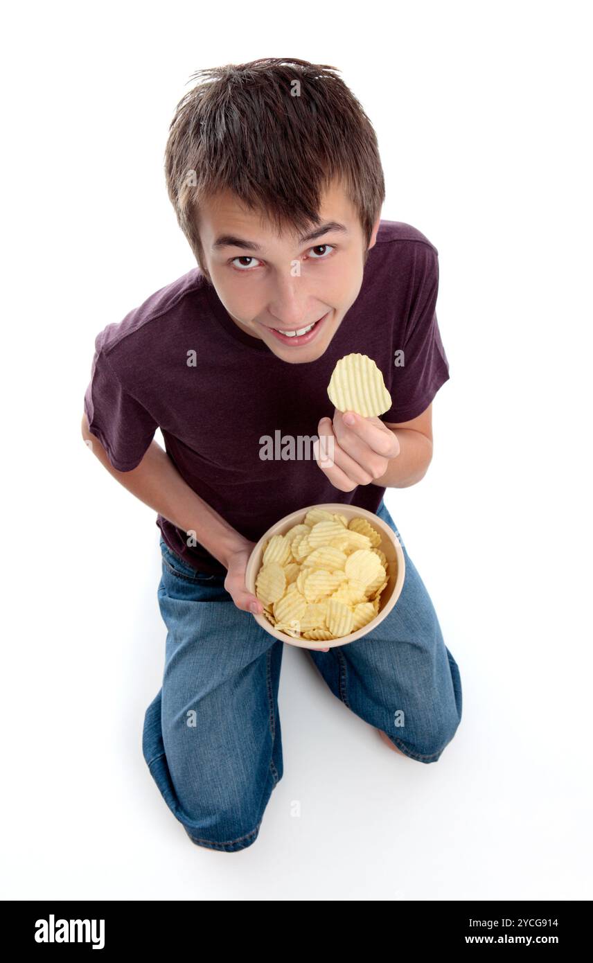 Boy eating potato crisp chip snack Stock Photo - Alamy