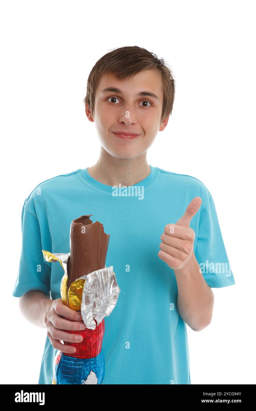 Boy eating chocolate rabbit Stock Photo - Alamy