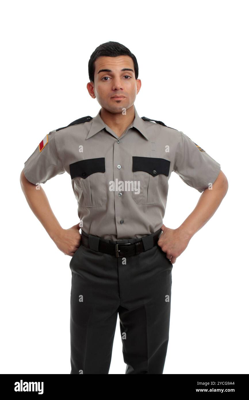 Prison guard, warden, or cop standing firm with hands on hip Stock ...