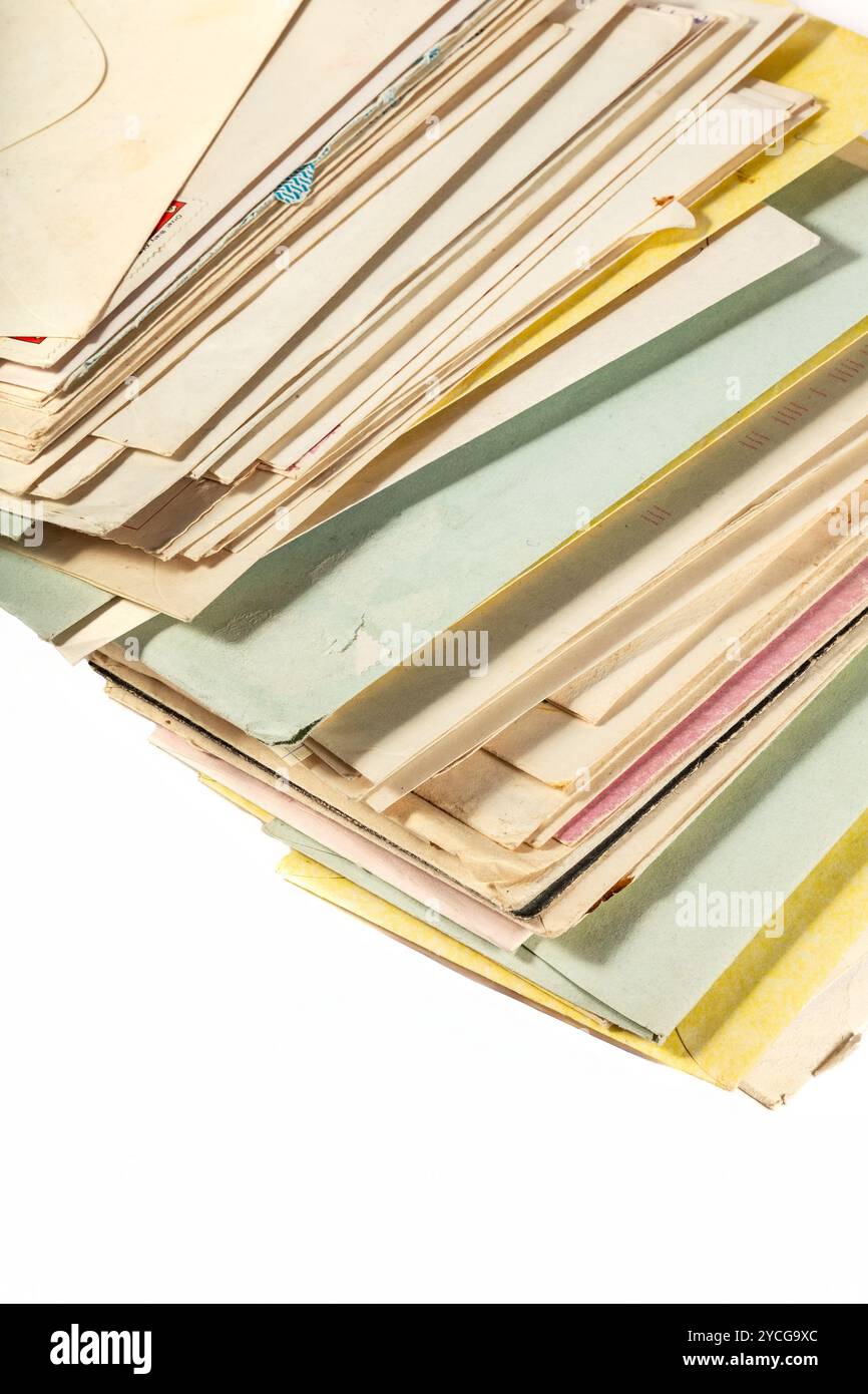 A scattered pile of old, damaged colored letters on a white background ...