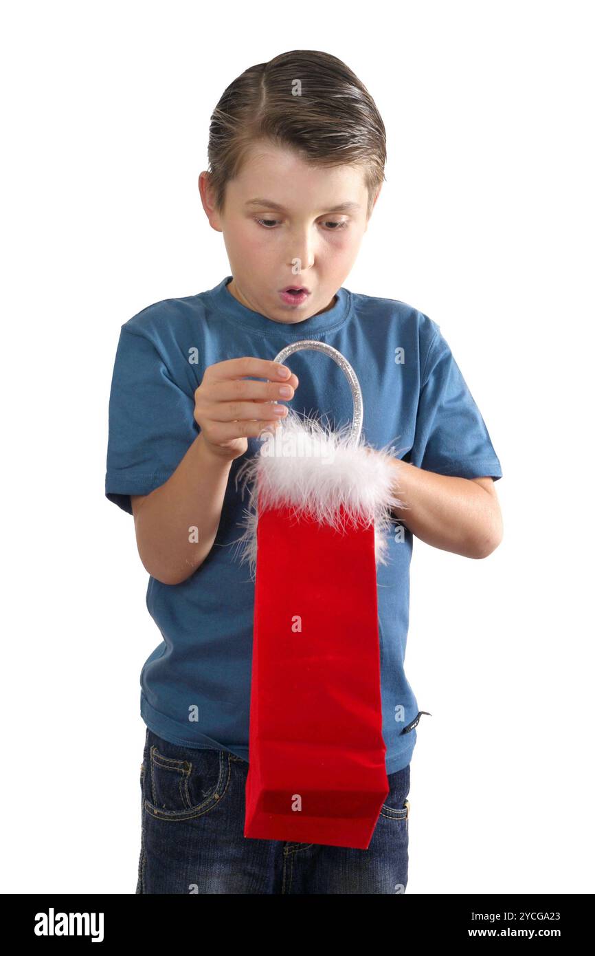 Curious boy looking inside a gift bag. White background Stock Photo - Alamy