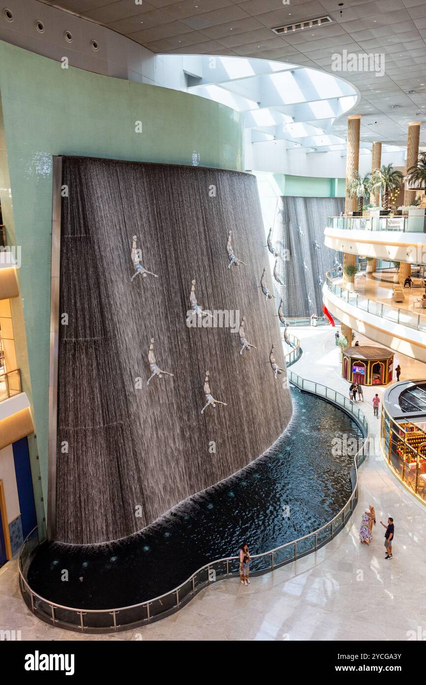 Diving men's sculptures of the iconic waterfall at the Dubai Mall in ...