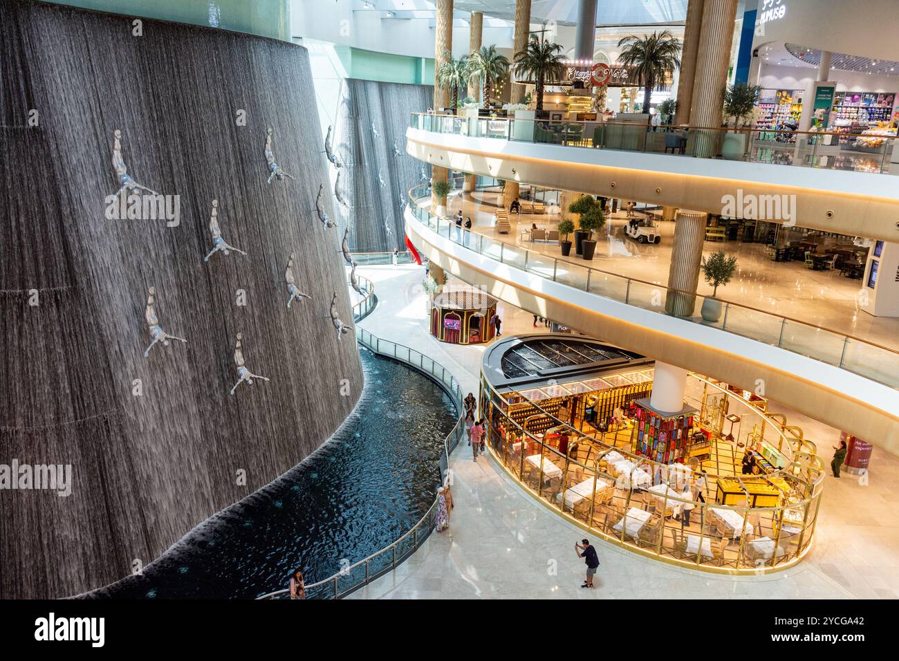 Diving men's sculptures of the iconic waterfall at the Dubai Mall in ...