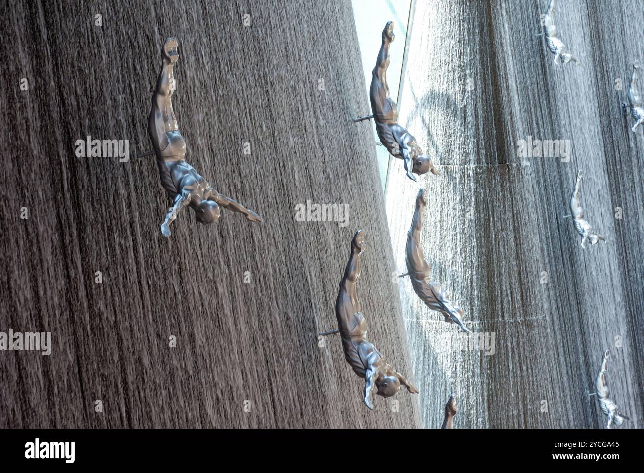 Diving men's sculptures of the iconic waterfall at the Dubai Mall in ...