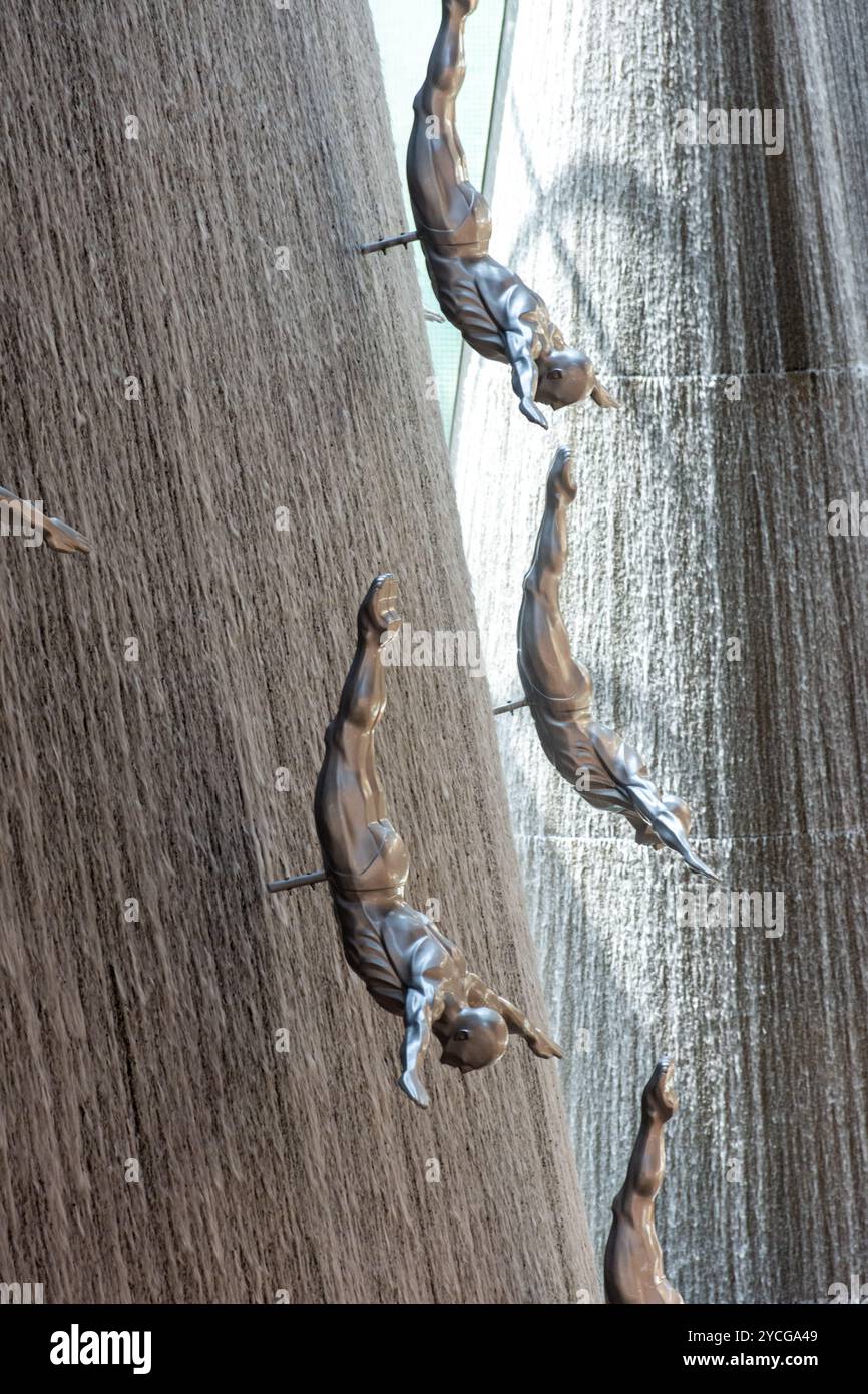 Diving men's sculptures of the iconic waterfall at the Dubai Mall in ...