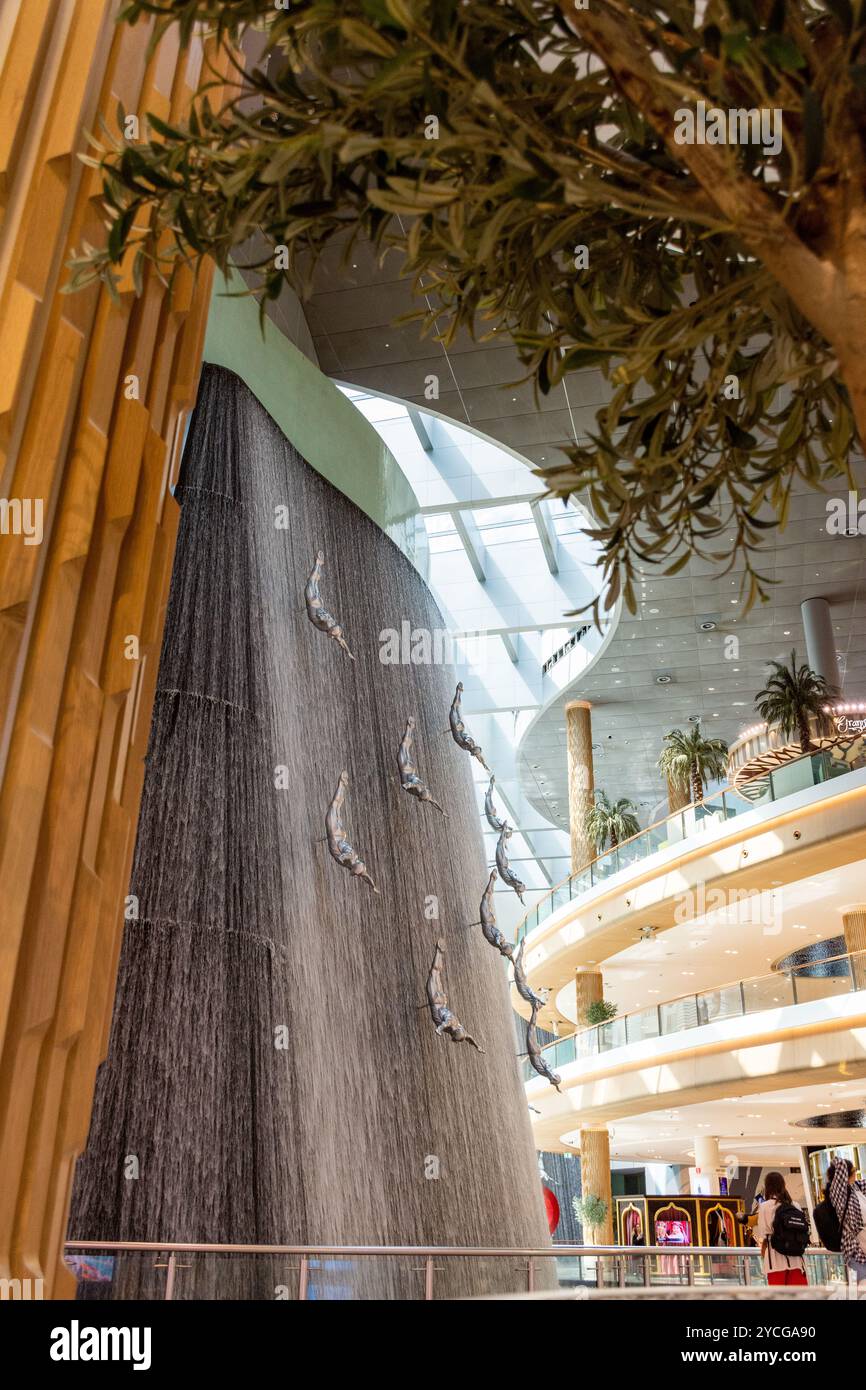 Diving men's sculptures of the iconic waterfall at the Dubai Mall in ...
