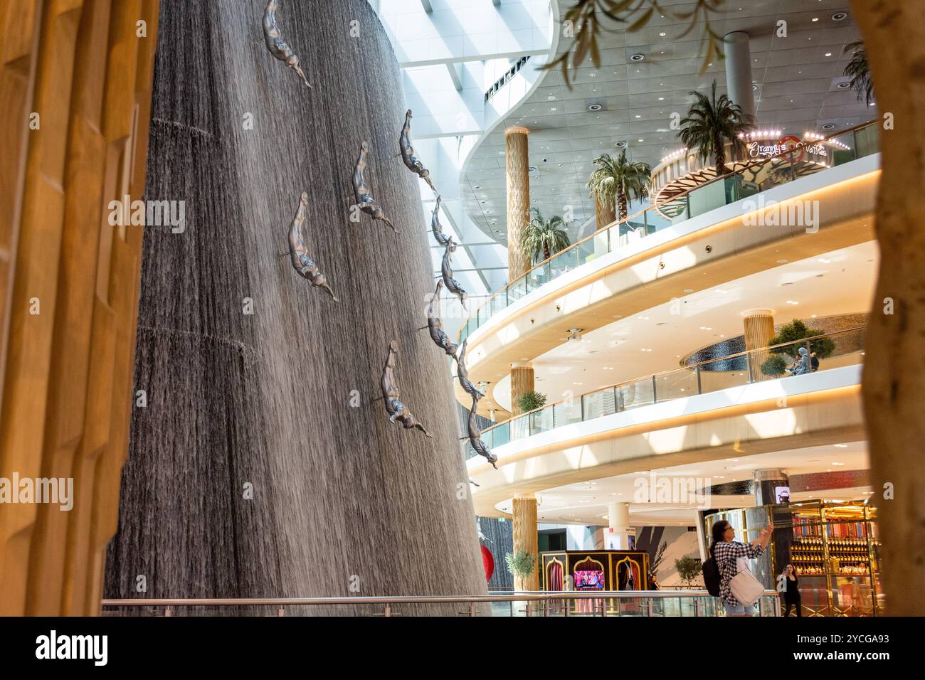 Diving men's sculptures of the iconic waterfall at the Dubai Mall in ...