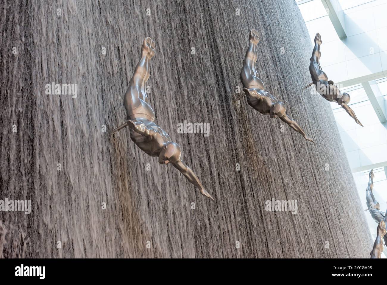 Diving men's sculptures of the iconic waterfall at the Dubai Mall in ...