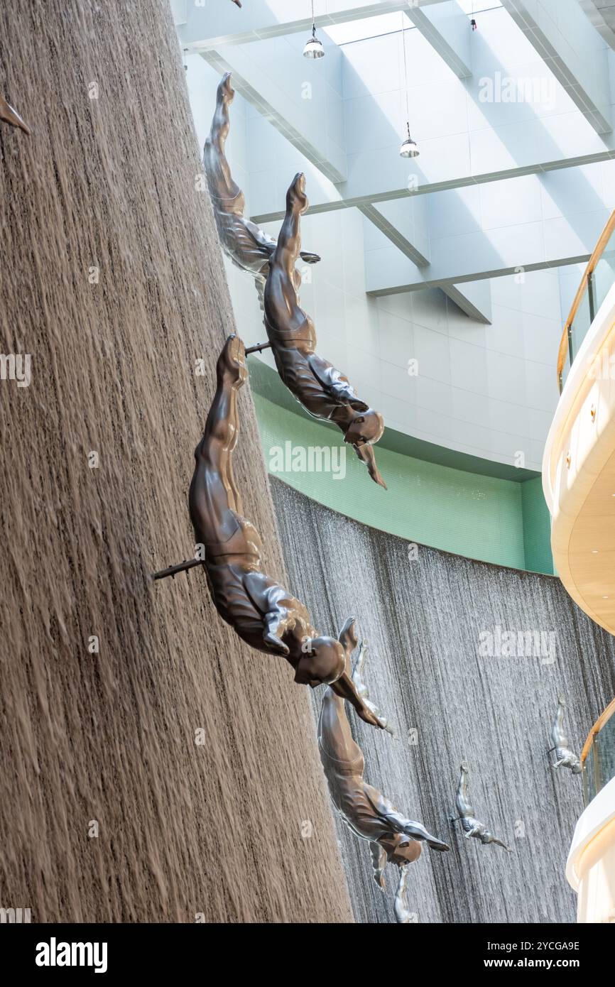 Diving men's sculptures of the iconic waterfall at the Dubai Mall in ...