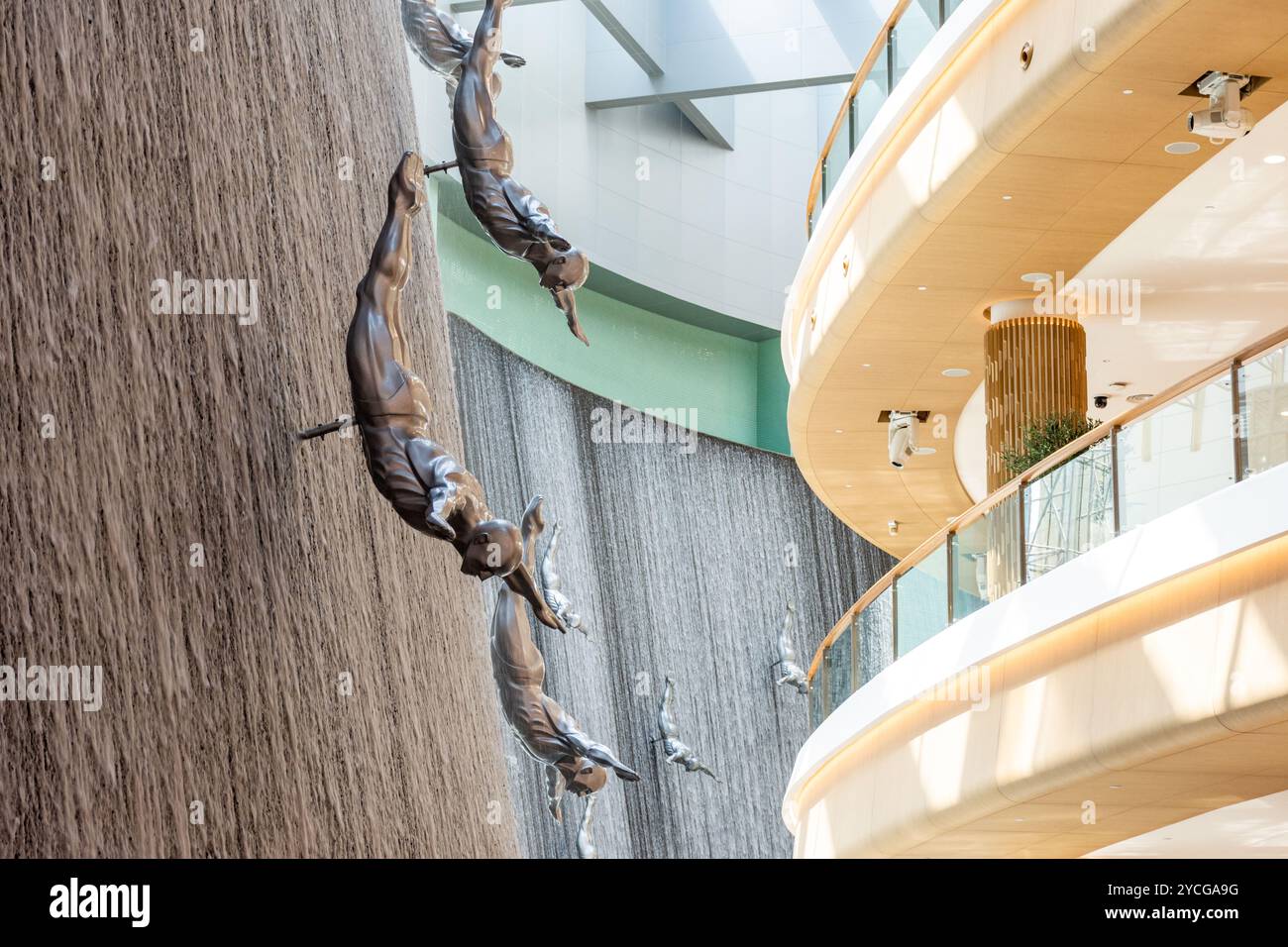 Diving men's sculptures of the iconic waterfall at the Dubai Mall in ...