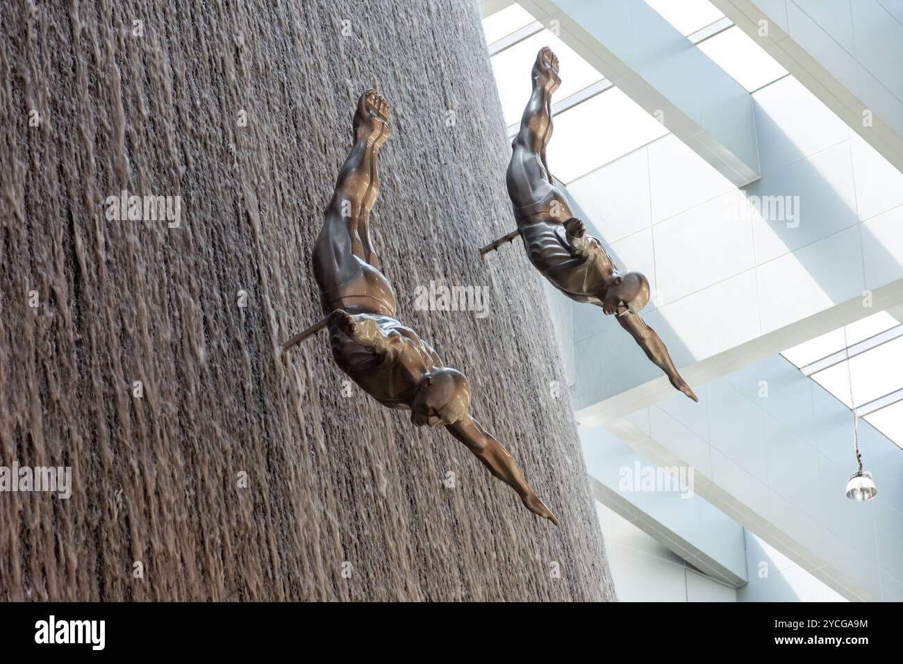 Diving men's sculptures of the iconic waterfall at the Dubai Mall in ...